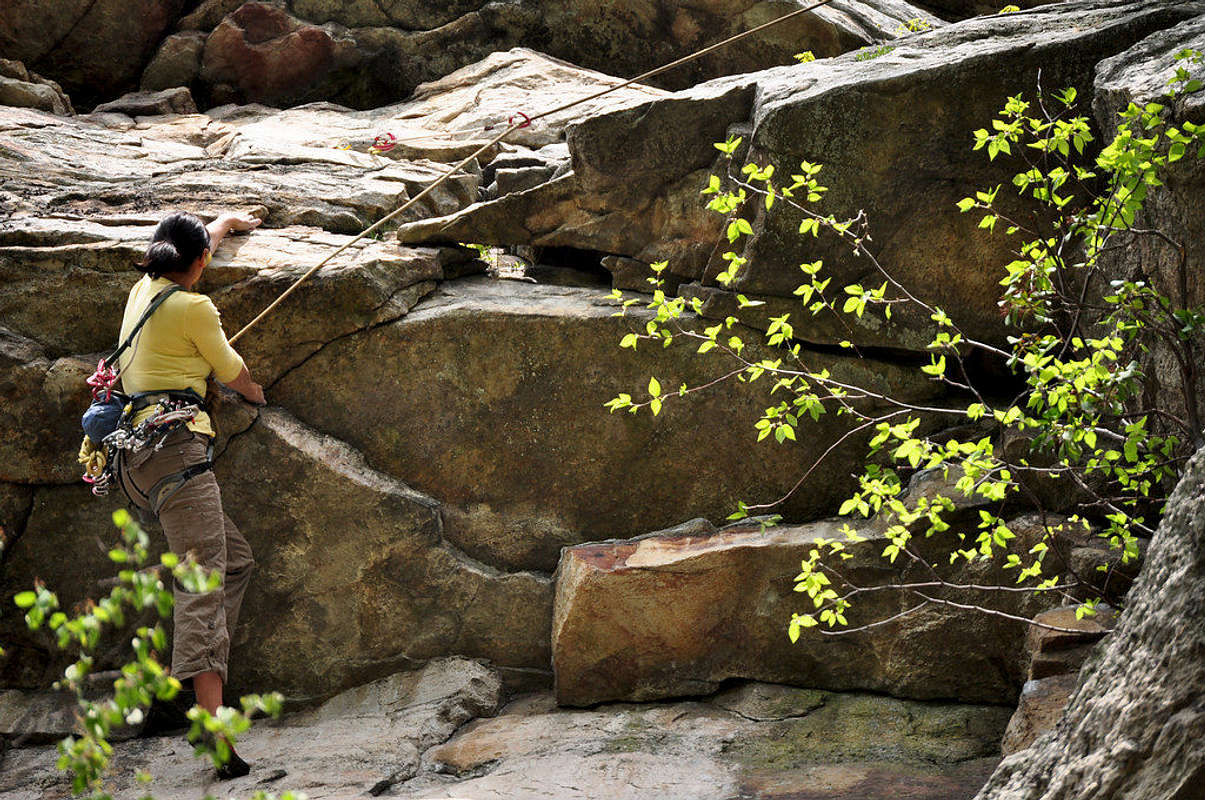 A climber surmounting the 'roof' of Ape Call, photo Denis O'Connor ...